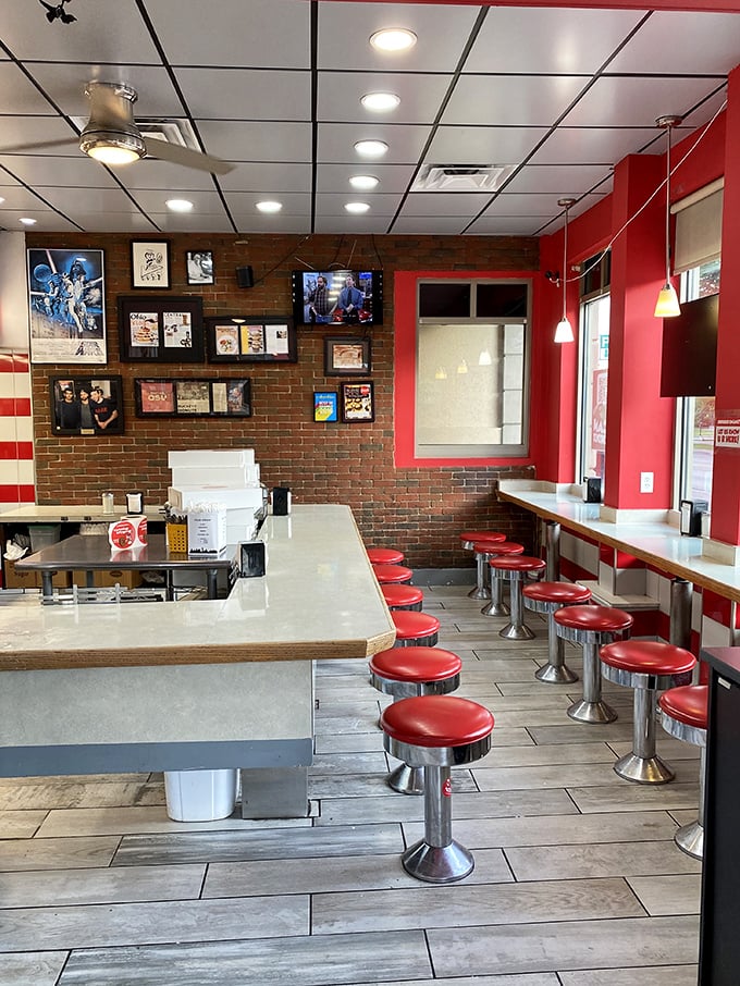 Diner-style seating with those classic red stools where strangers become friends over shared donut enthusiasm and coffee refills.