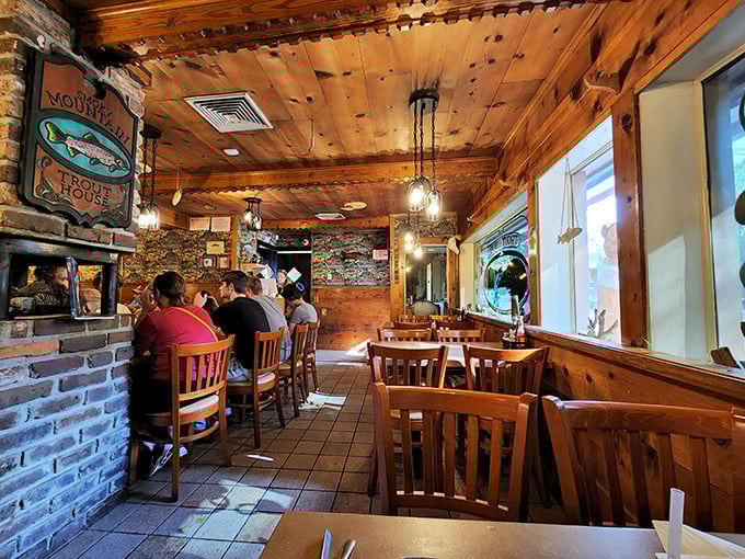 The dining room feels like it was carved from the heart of a giant pine tree – all wooden warmth and fishing memorabilia, where calories don't count and conversations flow easily.