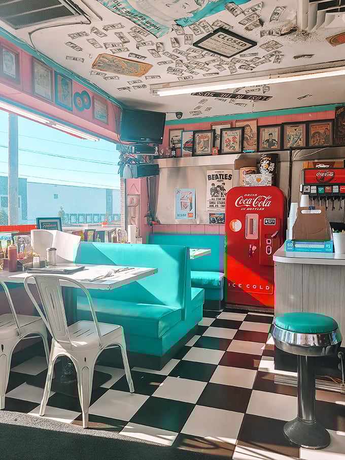 The pink walls and turquoise booths create the perfect backdrop for your breakfast dreams. That vintage Coca-Cola machine isn't just decoration – it's a sentinel of soda history.
