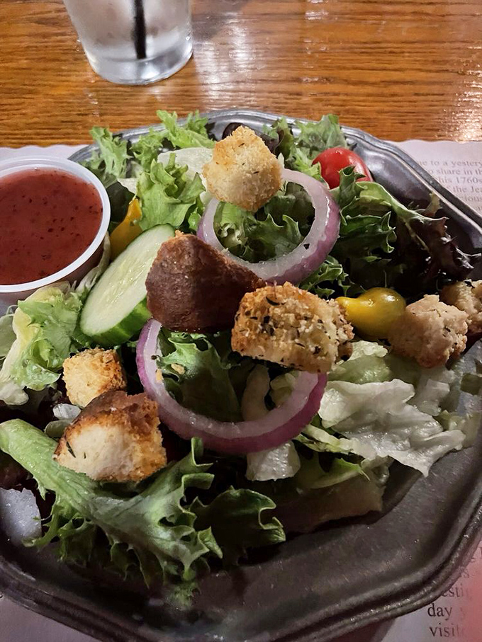 A house salad that knows its role—fresh, crisp, and ready to prepare your palate for the meaty main event waiting in the wings.