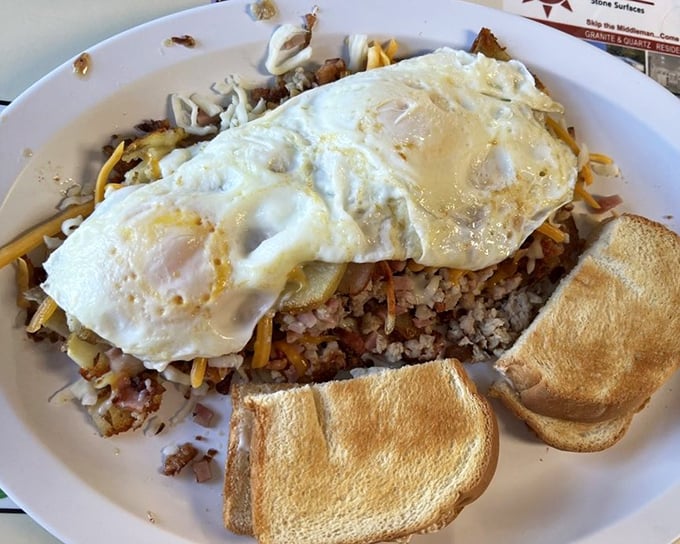 A skillet that means business—perfectly cooked eggs atop a foundation of potatoes and meat that turns breakfast into an adventure.