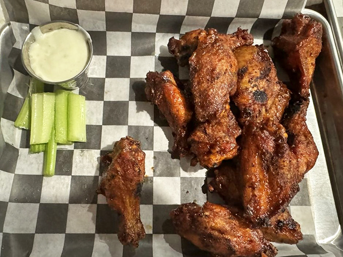 Smoked wings with the perfect crisp-to-juicy ratio, served with cooling celery and dip—proof that chicken can hold its own in a temple of barbecue.