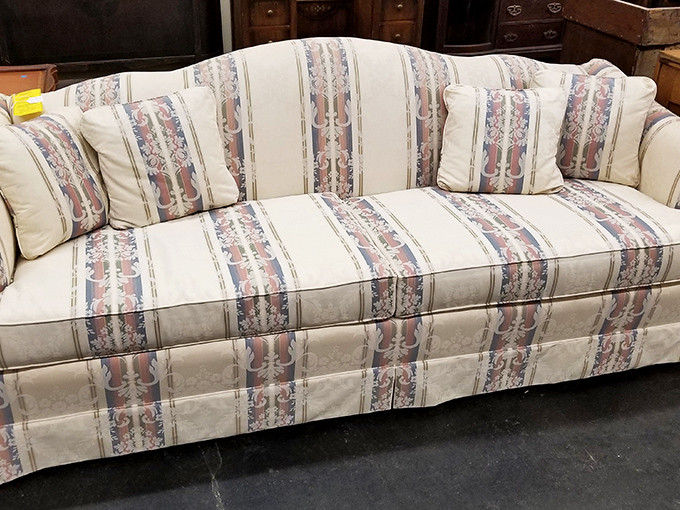 This sofa screams "1990s formal living room" – the kind nobody was allowed to sit on except visiting clergy and first dates meeting the parents.