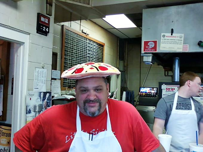 In the pizza business, wearing the product as a hat demonstrates both confidence and a healthy sense of humor about your life's work.