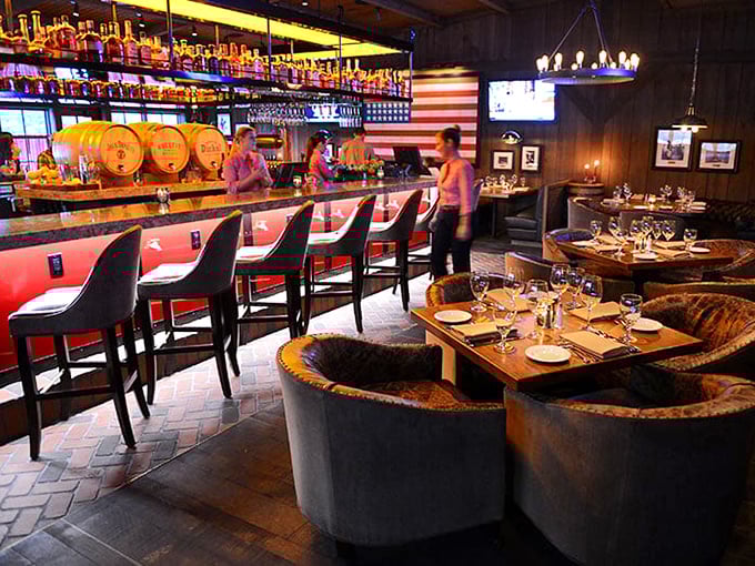 The bar area combines American flag pride with bourbon barrels and comfortable seating—patriotism never tasted so good.
