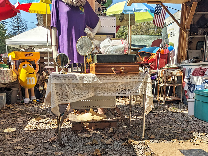 The tablecloth transforms ordinary folding tables into elegant retail establishments—just add one yellow M&M figurine for that touch of surreal charm.