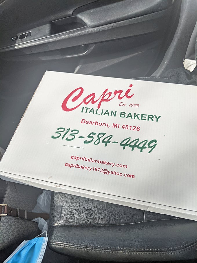 The bakery box—a simple cardboard vessel carrying precious cargo that transforms your car into an aromatic Italian paradise during the drive home.