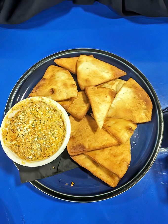 These aren't your average chips and dip—they're crispy vessels for a golden treasure that demands to be scooped with enthusiasm.