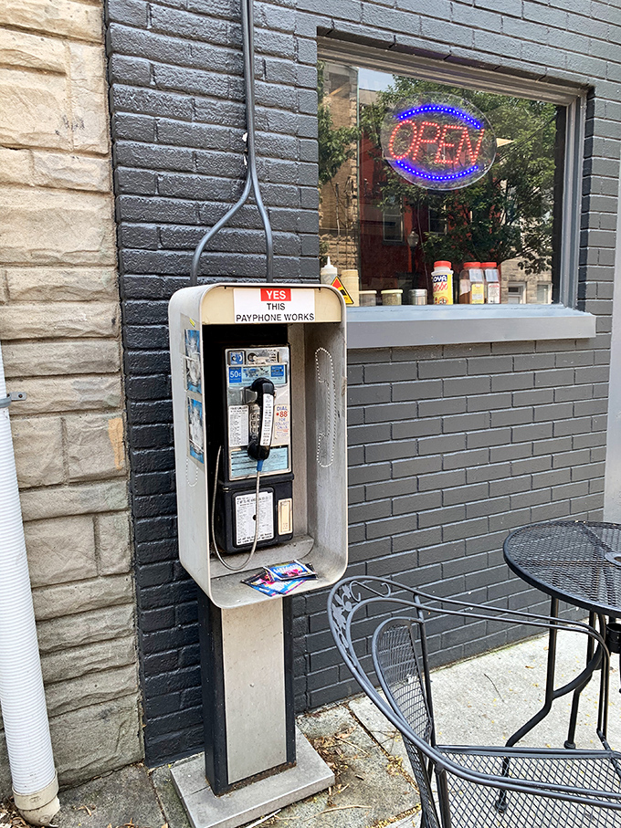 That working payphone outside is like a time portal to when food was simpler, tastier, and worth calling home about.