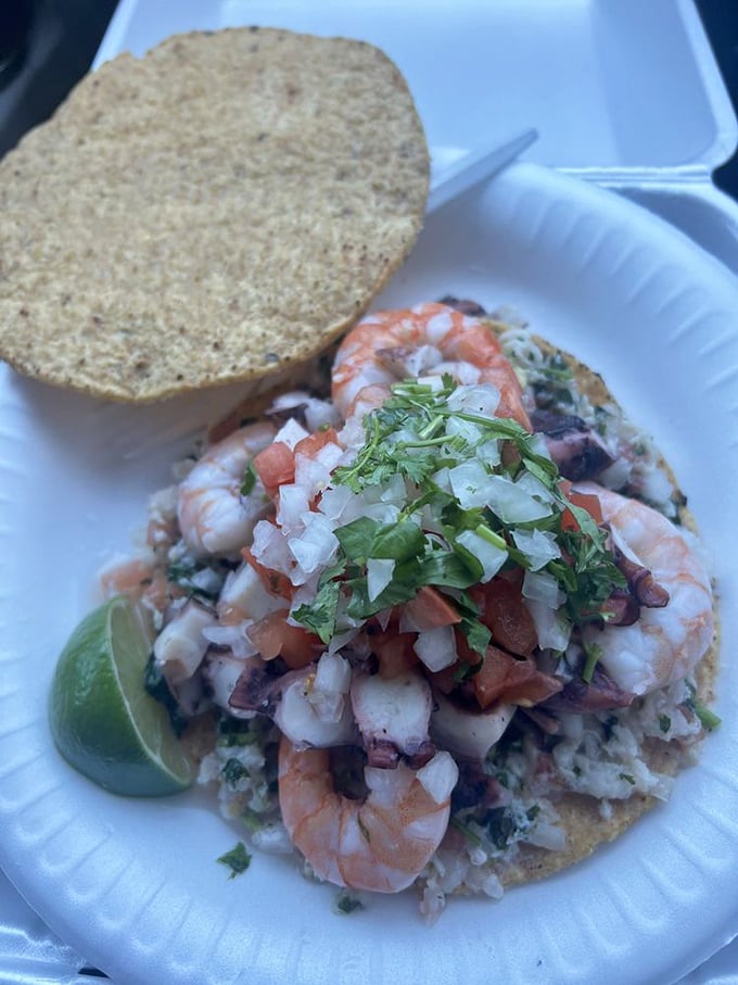 Architectural marvel meets culinary masterpiece. This tostada mixta stacks multiple seafood treasures so high you'll need a game plan to eat it.