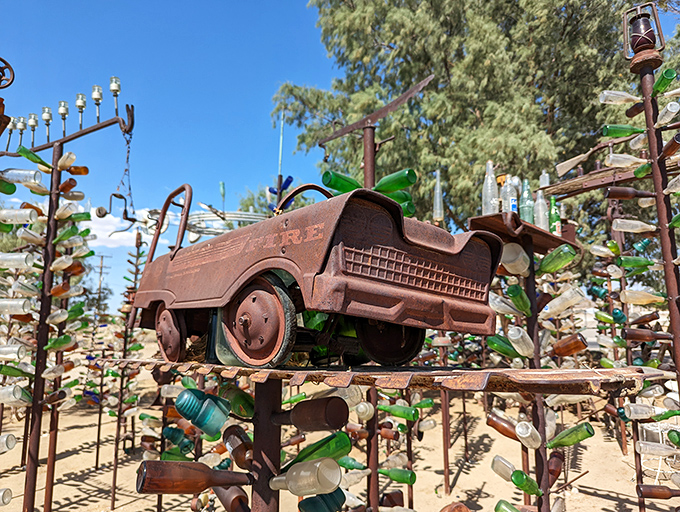 A child's pedal car elevated to art status, proving that in the desert, even toys get a second act as something magical.