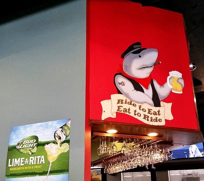 "Ride to Eat, Eat to Ride"—words to live by from a shark in a captain's hat. This whimsical wall art captures the Shrimp Shack's playful spirit.