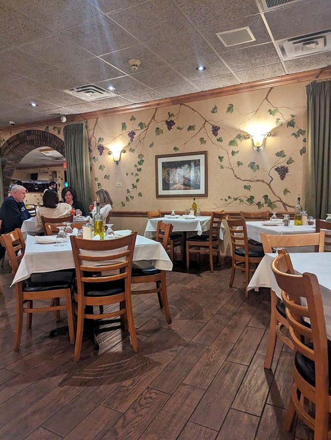 Those painted grape vines climbing the walls aren't just decoration—they're a visual promise of the wine-friendly feast that awaits you.