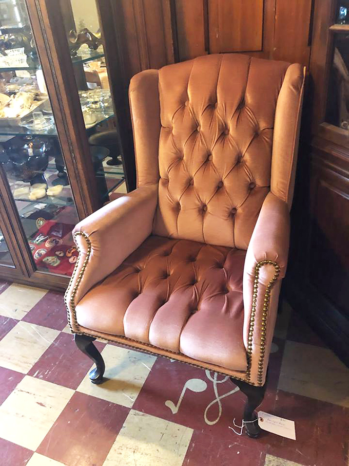 That tufted leather chair isn't just seating—it's a throne waiting for someone who appreciates the dignified comfort of another era.