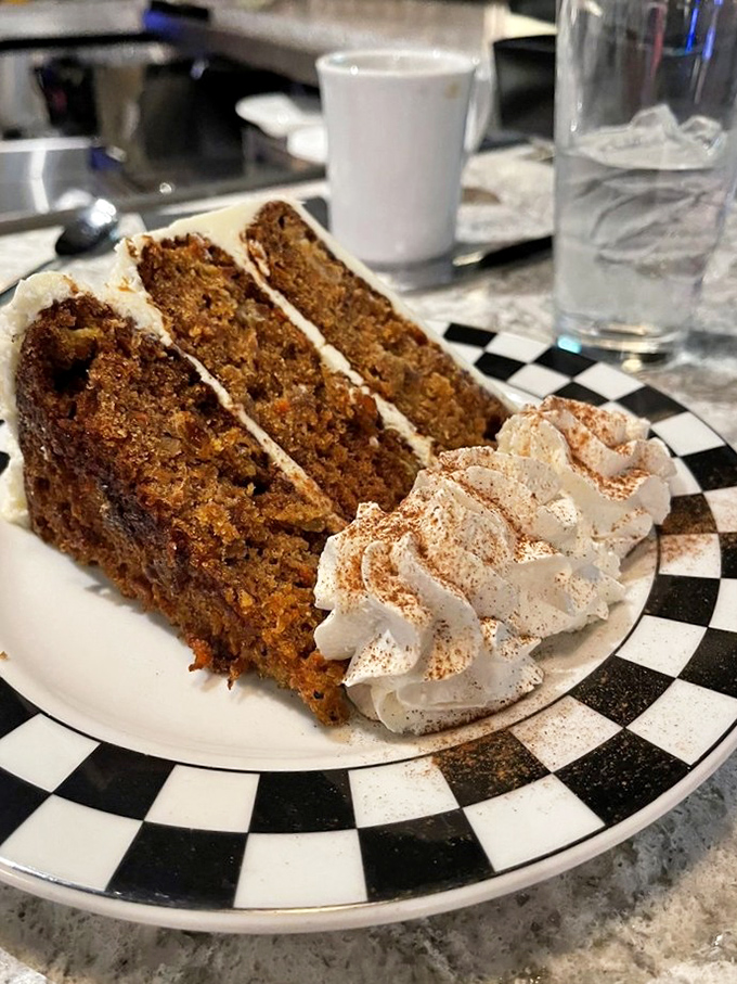 The 24K Carrot Cake—moist, spiced perfection with cream cheese frosting that makes you understand why people used to trade spices for gold.