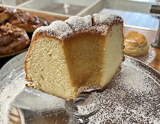 This isn't just cake – it's a cloud that somehow became solid, dusted with powdered sugar and waiting to dissolve on your tongue.