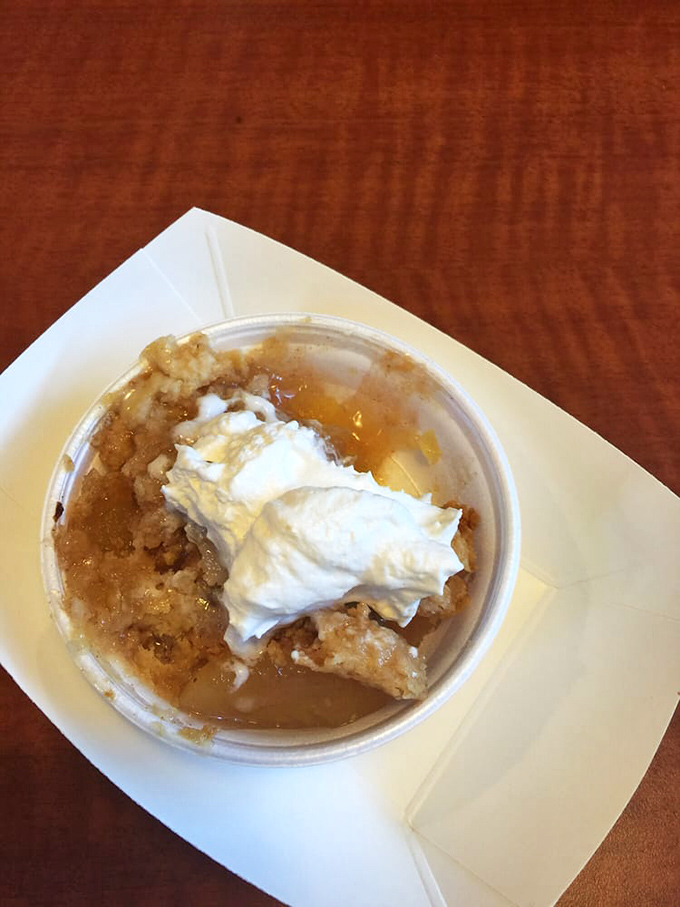 Apple cobbler topped with whipped cream—because after all that savory, your sweet tooth deserves its moment in the spotlight too.