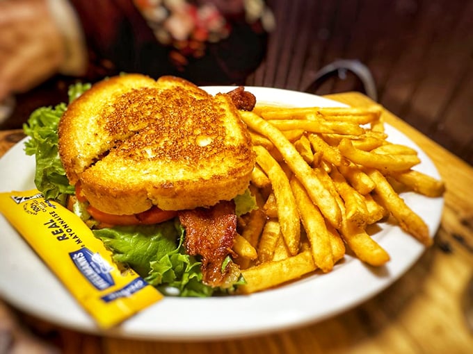 A BLT elevated to art form—golden toast, crisp bacon, and fries that make you wonder why anyone bothers with fancy restaurants.