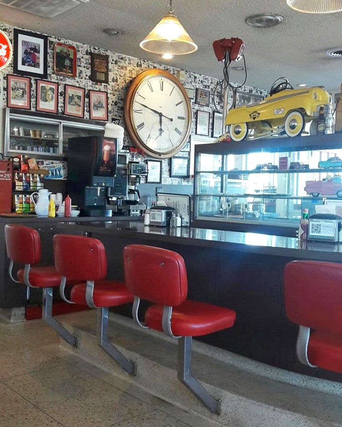 Those red counter stools aren't just seating—they're front-row tickets to the culinary show. The large clock reminds you that time tastes better here.