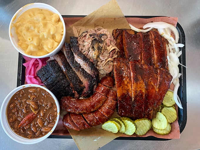 The barbecue platter that launched a thousand road trips—brisket, ribs, sausage, and sides arranged like a smoky work of art.