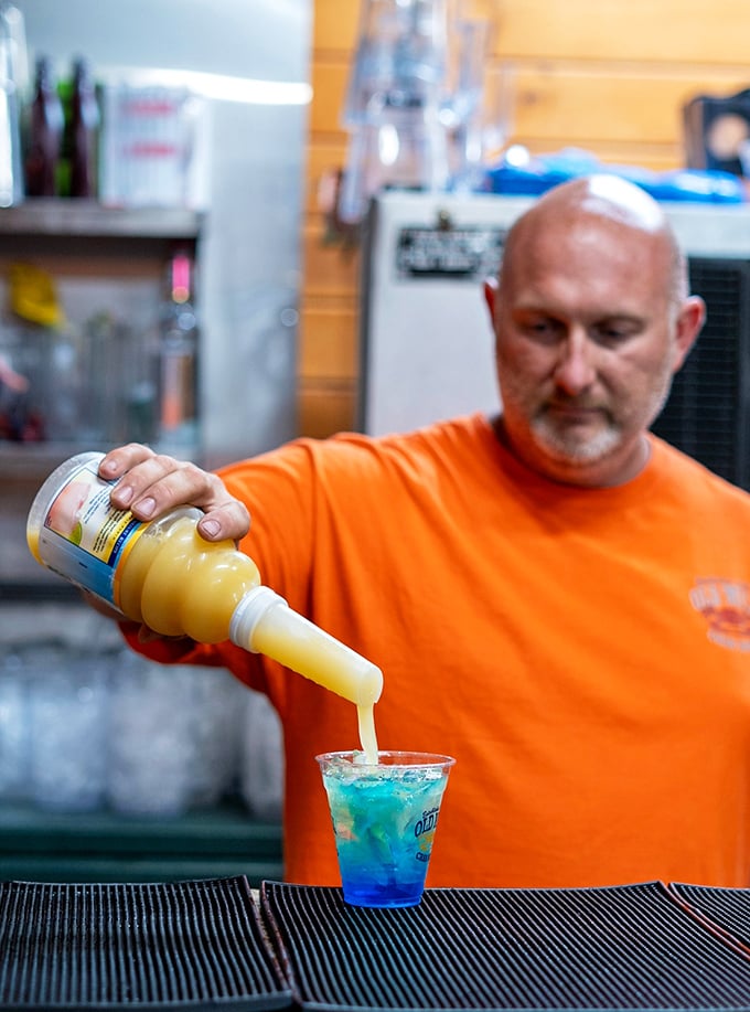 Mixology meets maritime tradition as colorful concoctions flow from skilled hands into eager glasses.