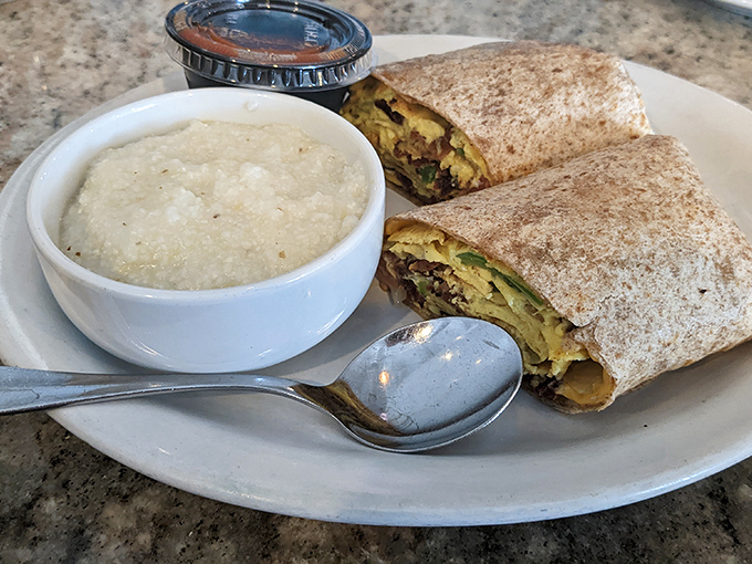 A breakfast burrito and grits—the dynamic duo of morning satisfaction. That spoon is poised for a dive into creamy comfort.
