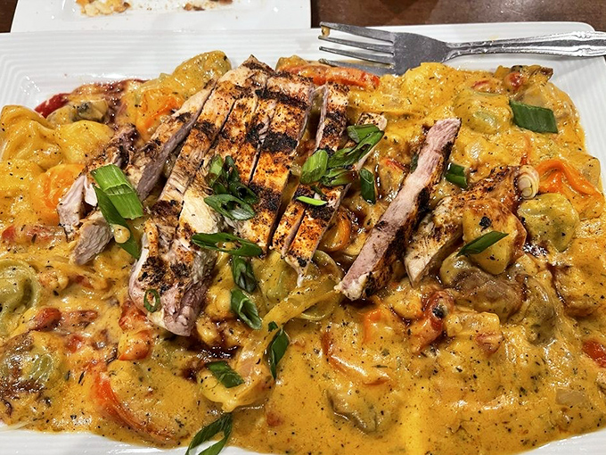 Tortellini swimming in a creamy Cajun sauce with perfectly grilled chicken—proof that Italian cuisine plays well with other flavor profiles.