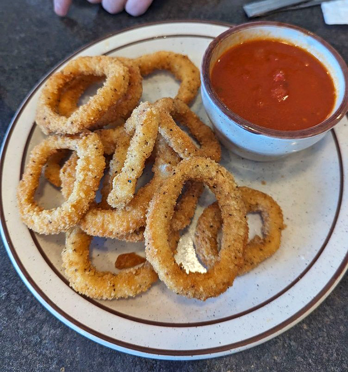 Crispy calamari rings with marinara—proof that even seafood gets the respect it deserves at this unpretentious diner.