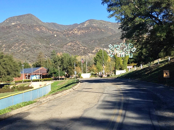 The road to Camp Ramah winds through quintessential California landscape—mountains rising dramatically behind modest buildings and verdant fields.
