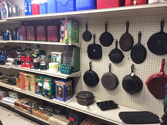 Cast iron cookware hanging like dark culinary medals—each pan seasoned with decades of family dinners and campfire stories.