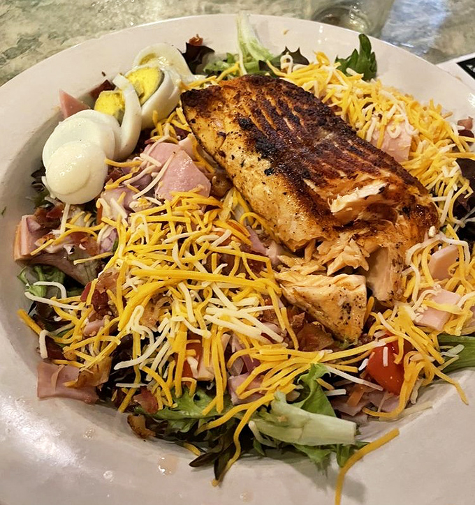 This isn't just a salad—it's a celebration. Grilled chicken perched atop a mountain of fresh ingredients like a delicious king of the hill.