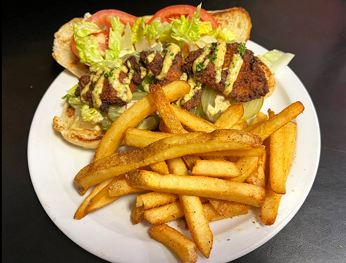 That chicken po'boy is dressed to impress, with fries that deserve their own fan club.