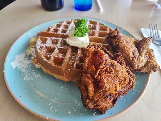 Chicken and waffles: the perfect marriage of sweet and savory, served on a blue plate that makes the golden-brown duo pop like edible celebrities.
