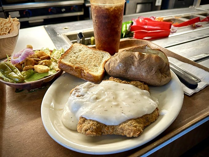 Chicken fried steak swimming in creamy gravy isn't just comfort food—it's a warm hug from the state of Texas itself.