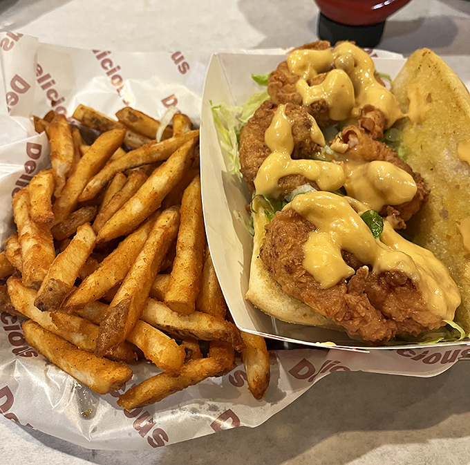 This po' boy isn't just a sandwich—it's architectural genius. The golden-fried protein nestled in that soft bread with remoulade sauce cascading down is poetry in carb form.