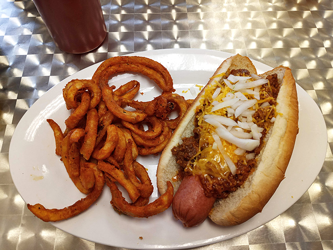 This chili cheese dog with curly fries isn't just lunch—it's proof that sometimes the simplest pleasures are the most satisfying.