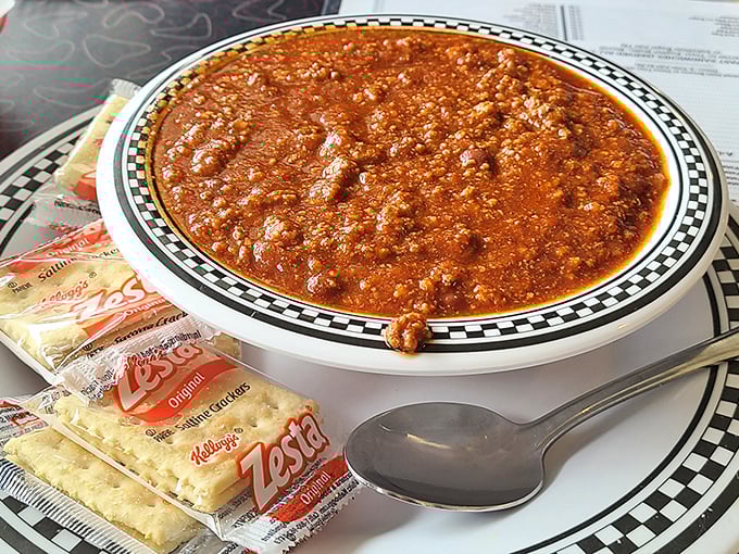 Chili that demands respect – rich, hearty, and thick enough to stand a spoon in, served with crackers for essential structural support.