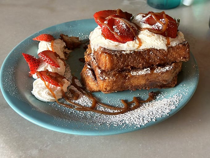 This isn't just French toast—it's an architectural achievement with whipped cream mortar and strawberry shingles.