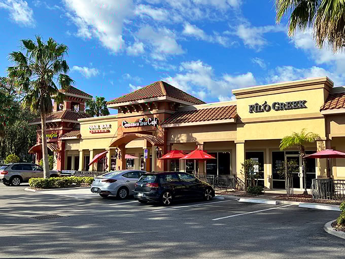 Strip mall dining at its finest—where red umbrellas beckon and the promise of air conditioning is almost as enticing as the menu.