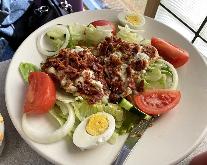 This Cobb salad makes eating greens feel like cheating – where bacon bits and hard-boiled eggs transform lettuce into something worth celebrating.