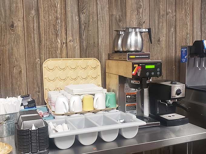 Coffee station ready for the morning rush—where mugs wait patiently for their daily purpose of delivering liquid motivation to Shelbyville's early risers.