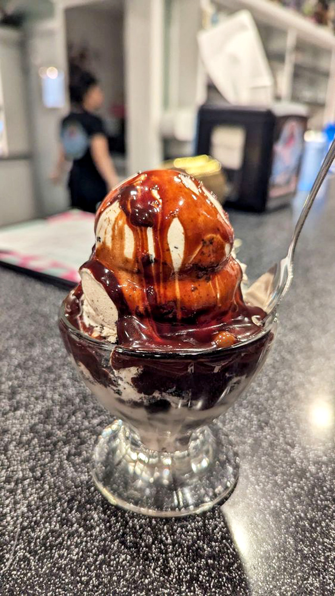 This isn't just hot fudge cascading over ice cream—it's a chocolate waterfall that would make Hemingway write an entire novel about desire.