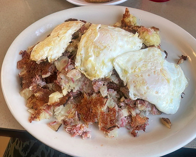 Corned beef hash topped with eggs – breakfast of champions or the perfect hangover cure? The correct answer is "absolutely both."