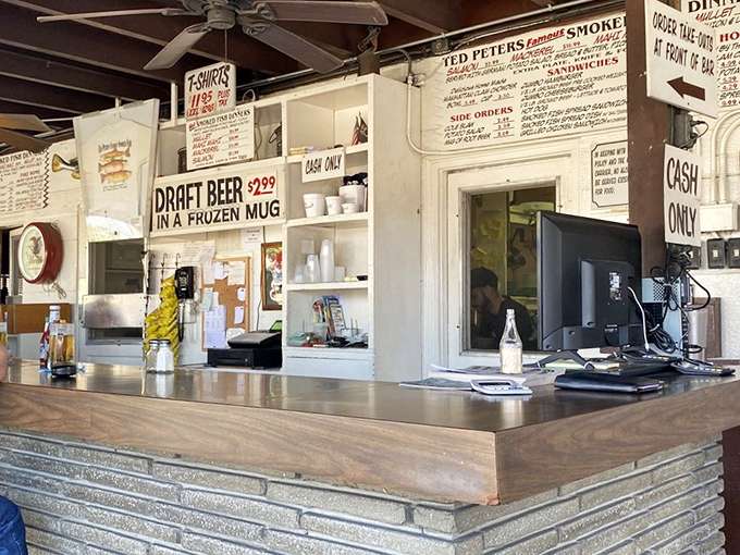 The counter where magic happens. Hand-written menus, frozen beer mugs, and cash-only signs—all indicators you've found authentic Florida gold.