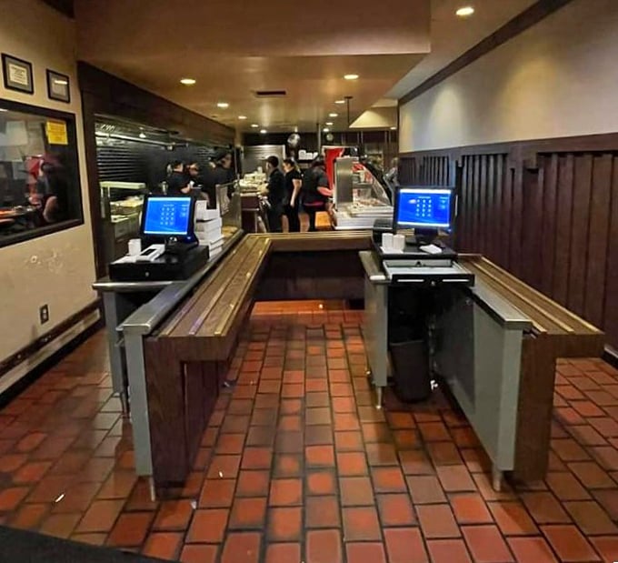 The cafeteria-style service line is where the magic begins—pick your tray, place your order, and watch as your steak sizzles on the grill before your eyes.