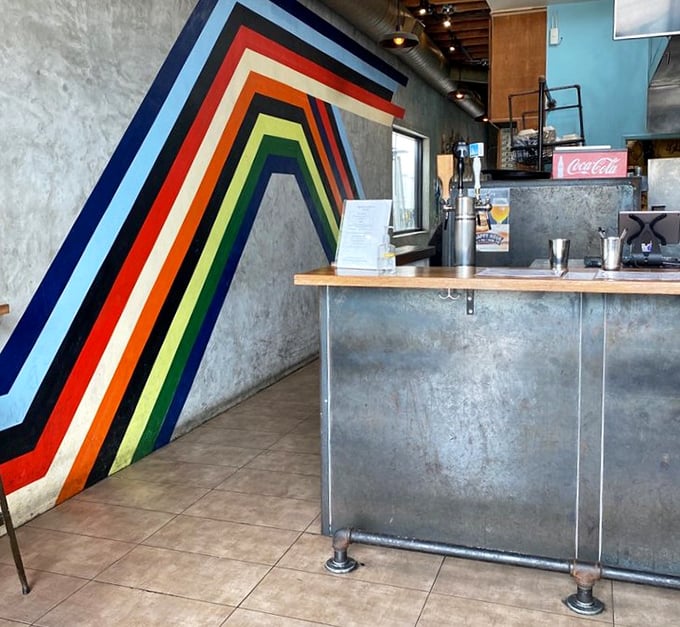 The rainbow stripe continues its journey across the wall, leading your eye—and soon your appetite—straight to the ordering counter.