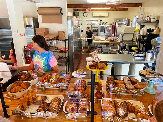 Where the magic happens: a glimpse into the kitchen reveals the organized chaos behind every perfect bite. Those pastry cases are like jewelry displays for edible gems.