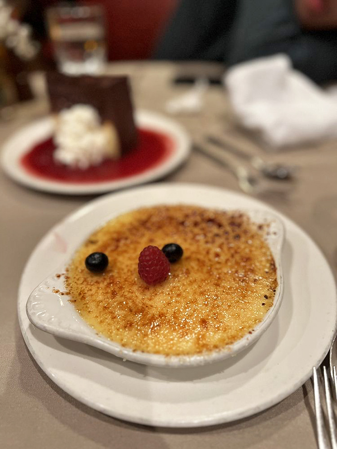 The crème brûlée arrives with that perfect glass-like sugar top that makes the most satisfying crack when your spoon breaks through to the creamy custard below.