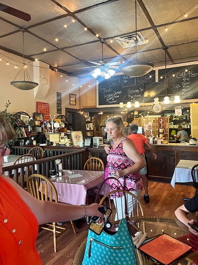 The dining room buzzes with locals and visitors alike. String lights cast a warm glow over conversations that flow as easily as the coffee refills. 