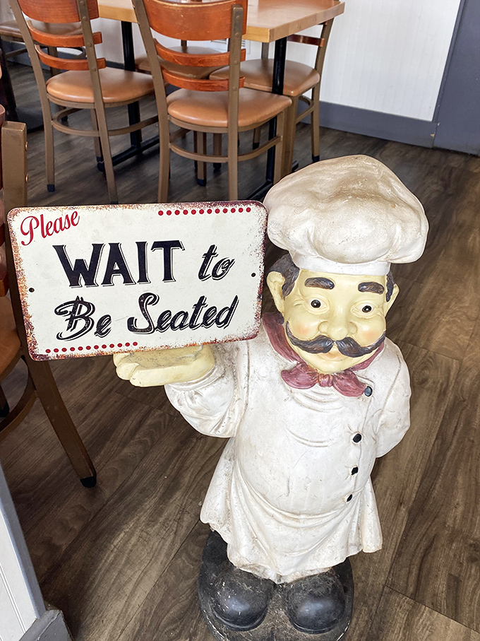 The chef statue's "Please WAIT to Be Seated" sign isn't just cute—it's delivered with the kind of authority that makes you instantly comply.